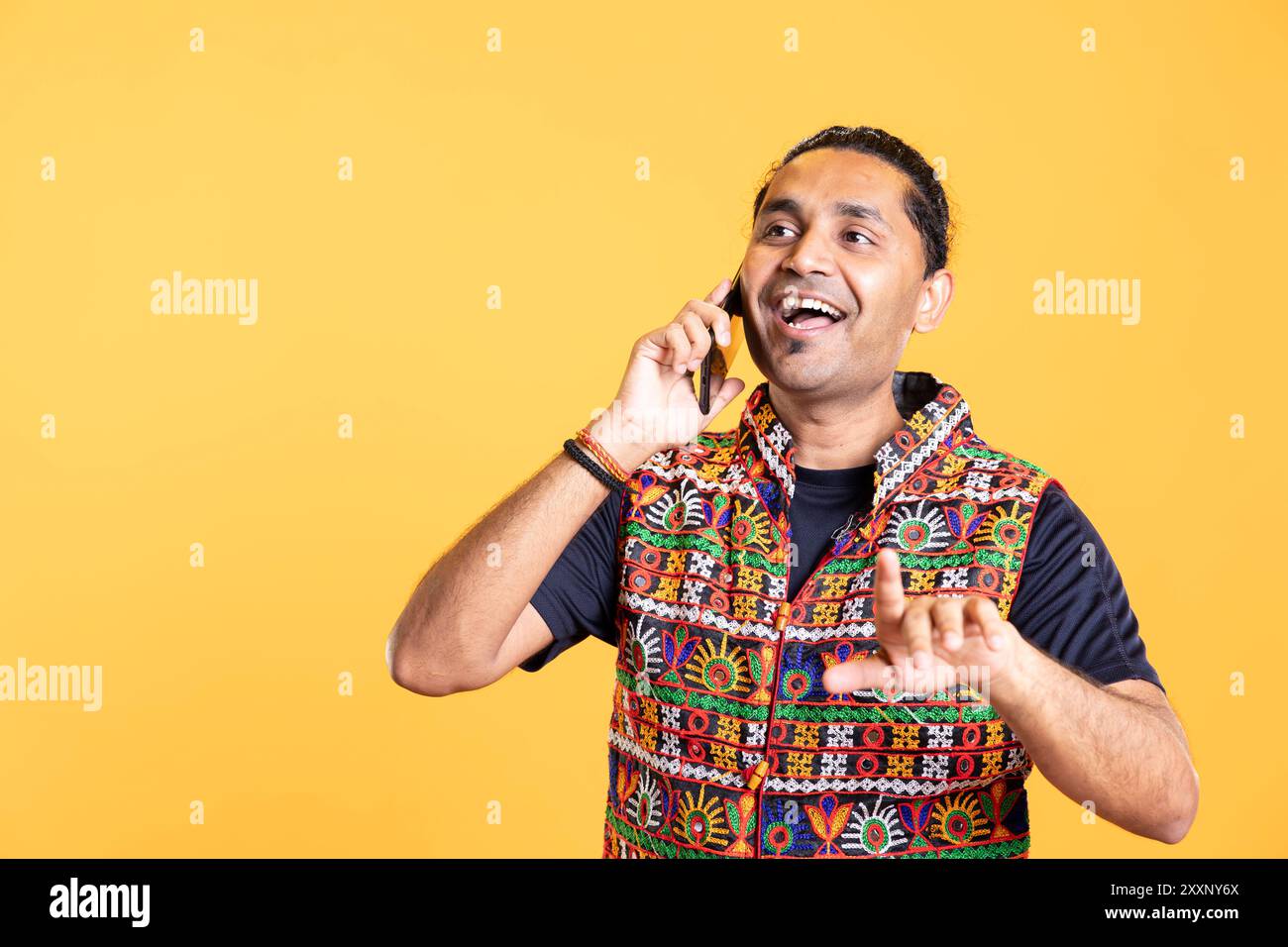 Cheerful man laughing at funny jokes with best friend over telephone ...