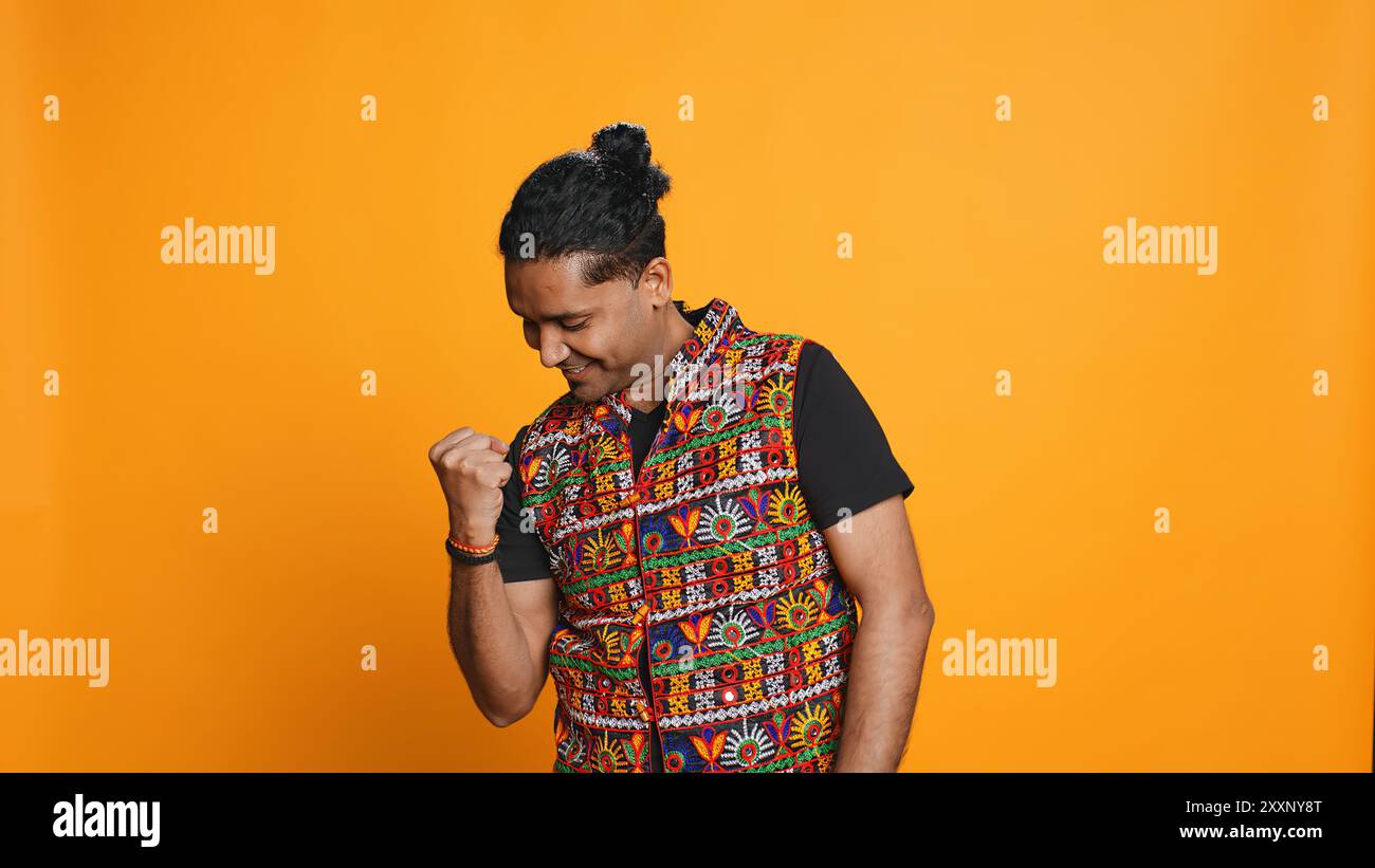 Portrait of joyful indian man celebrating, showing positive emotions ...