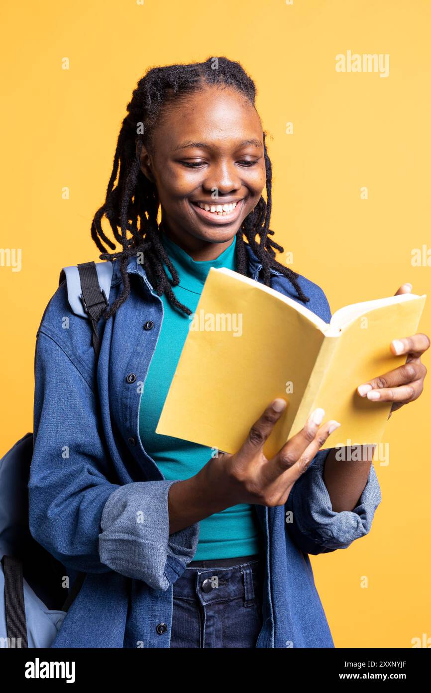 Happy woman reading interesting book and grinning, enjoying hobby ...
