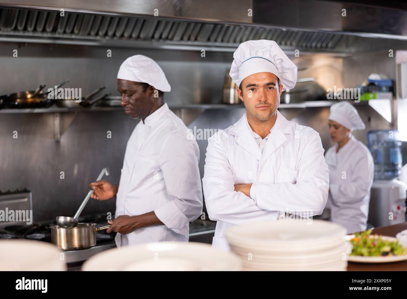 Portrait of chef with arms crossed in restaurant kitchen Stock Photo ...