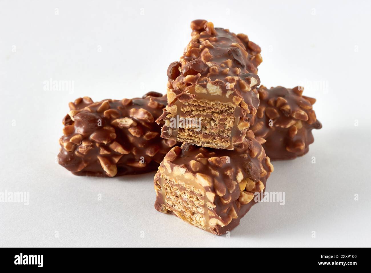 Cross-section of wafer caramel bar with nuts and chocolate glaze on ...