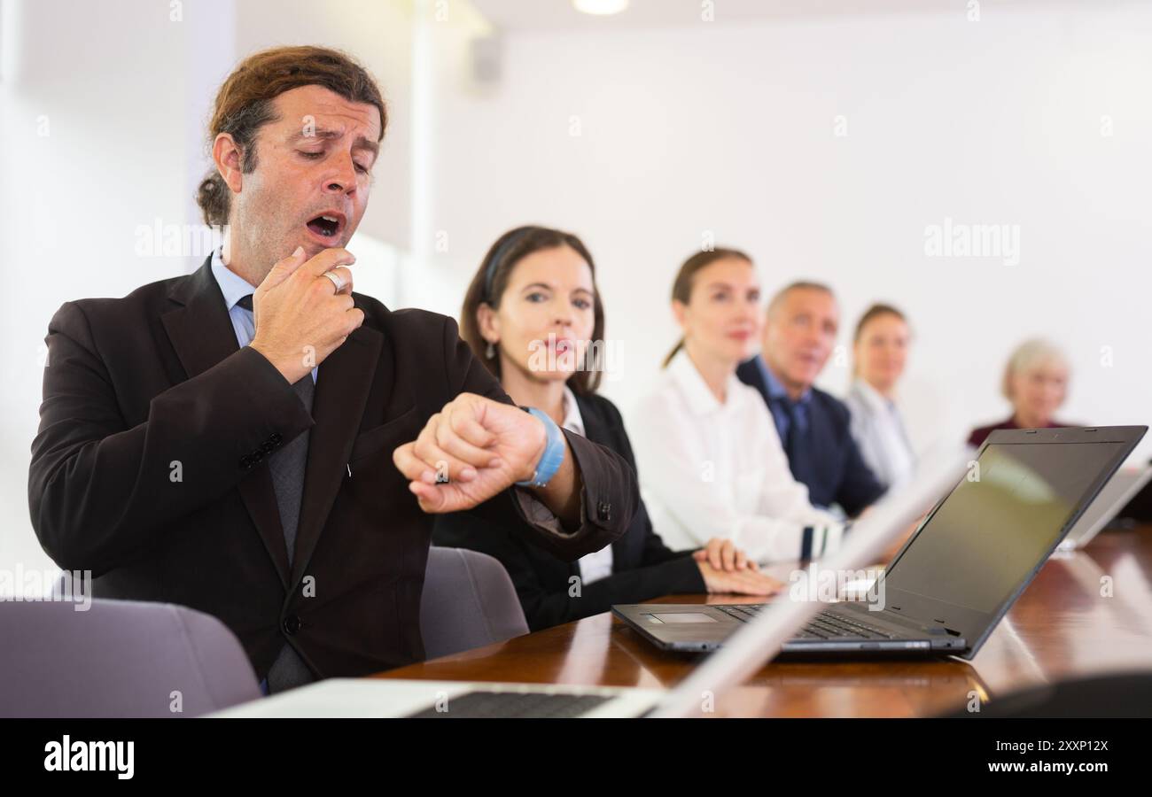 Middle aged white business man yawning at boring meeting Stock Photo ...