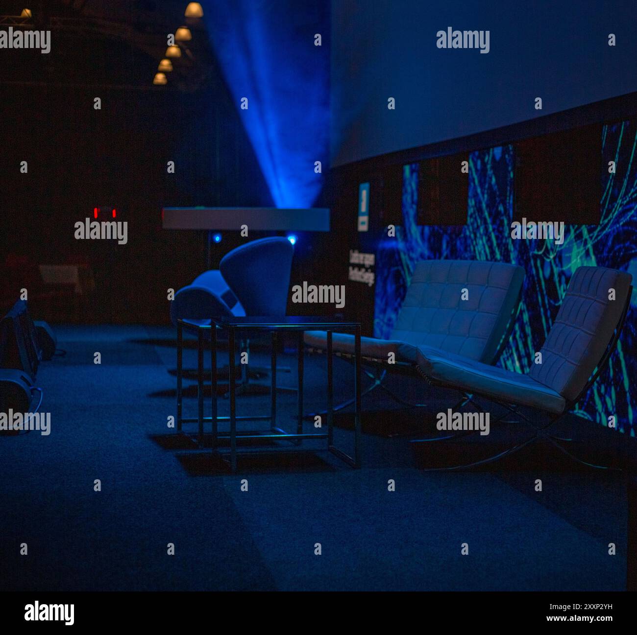 Chairs on a stage in a blue light Stock Photo - Alamy