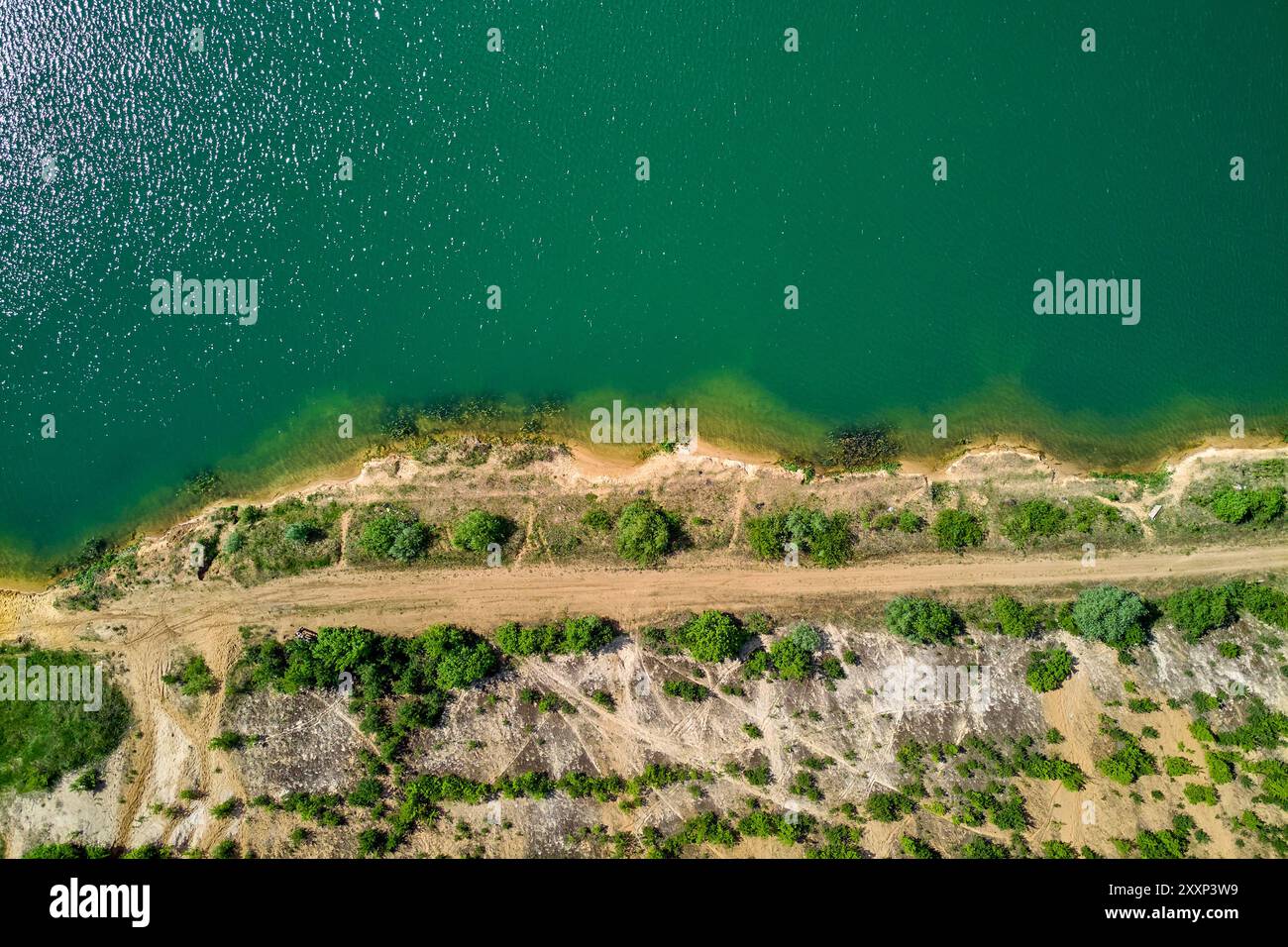 Aerial view of the coastline of a flooded sand quarry Stock Photo - Alamy
