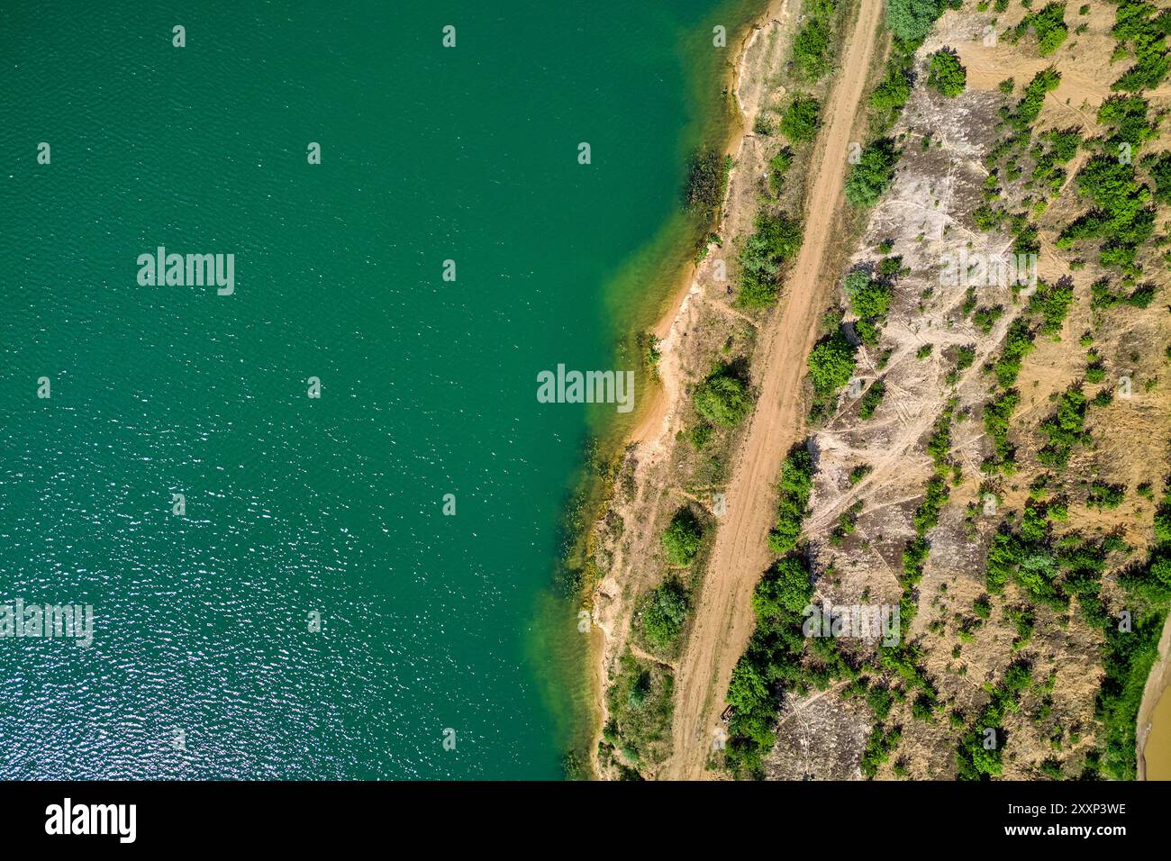 Aerial view of the coastline of a flooded sand quarry Stock Photo - Alamy
