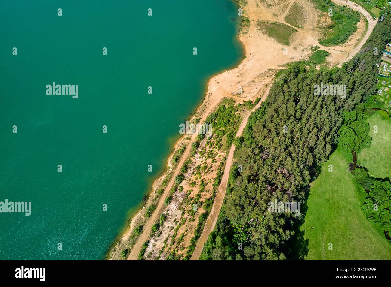 Turquoise waters of a flooded sand quarry, view from above Stock Photo ...