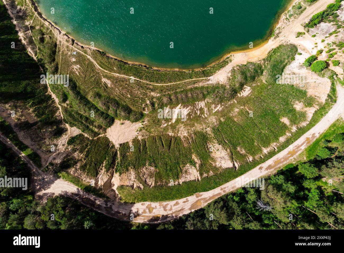 Top view of a steep slope of a flooded sand quarry Stock Photo - Alamy