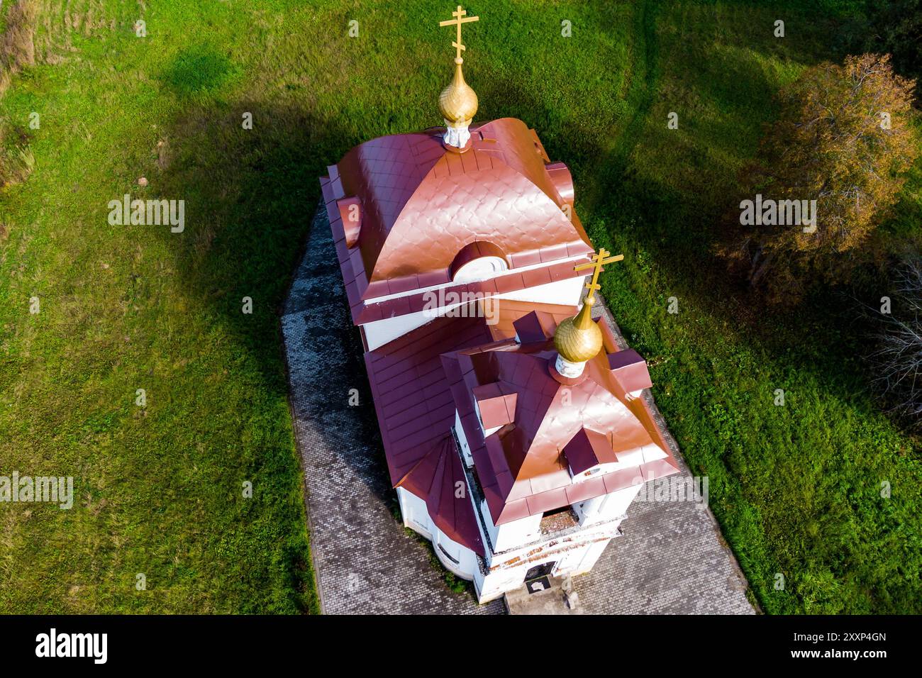 Top view of the renovated roof of an ancient rural church with gilded ...