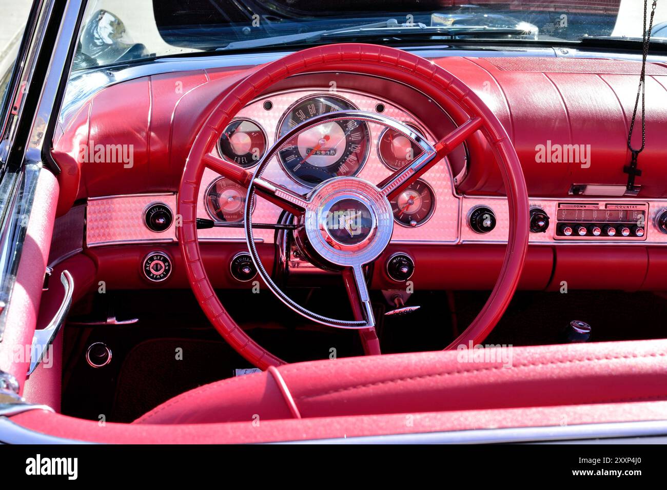 Red and chrome instrument cluster of a 55 Ford Thunderbird convertible ...