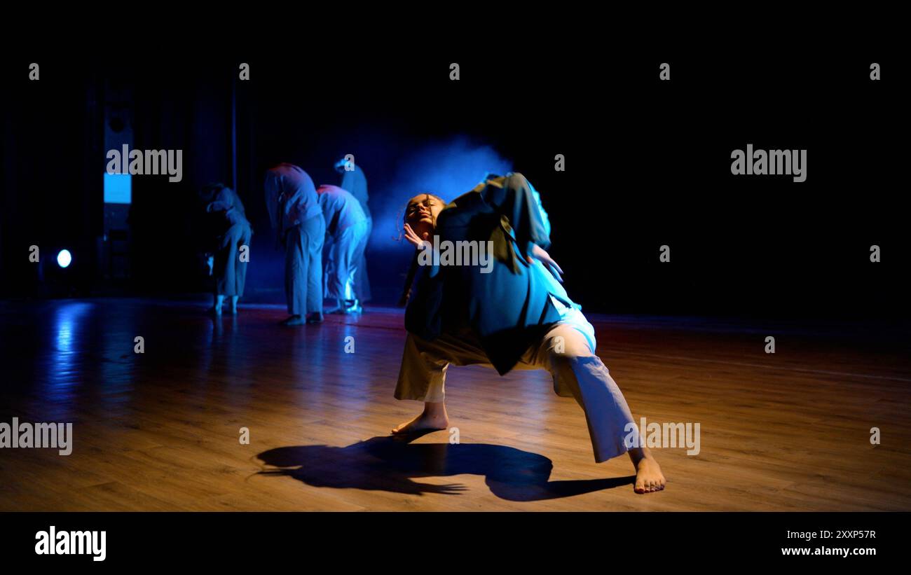 Beautiful movements of a dancer. Performance, girls lying on stage ...