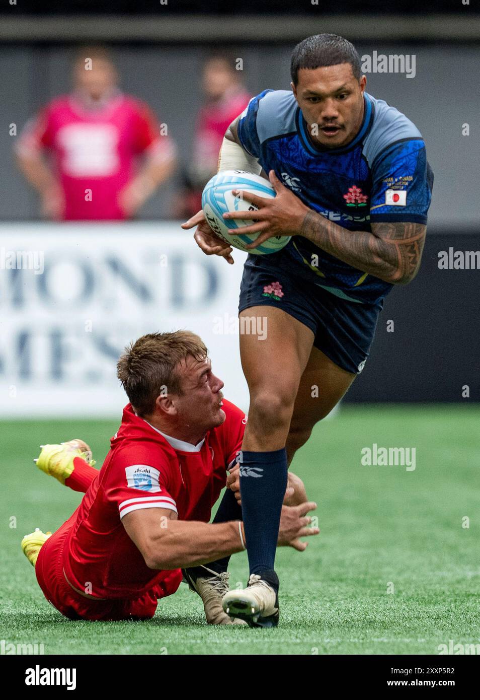 Canada's Ethan Fryer tackles Japan's Malo Tuitama during the first half ...