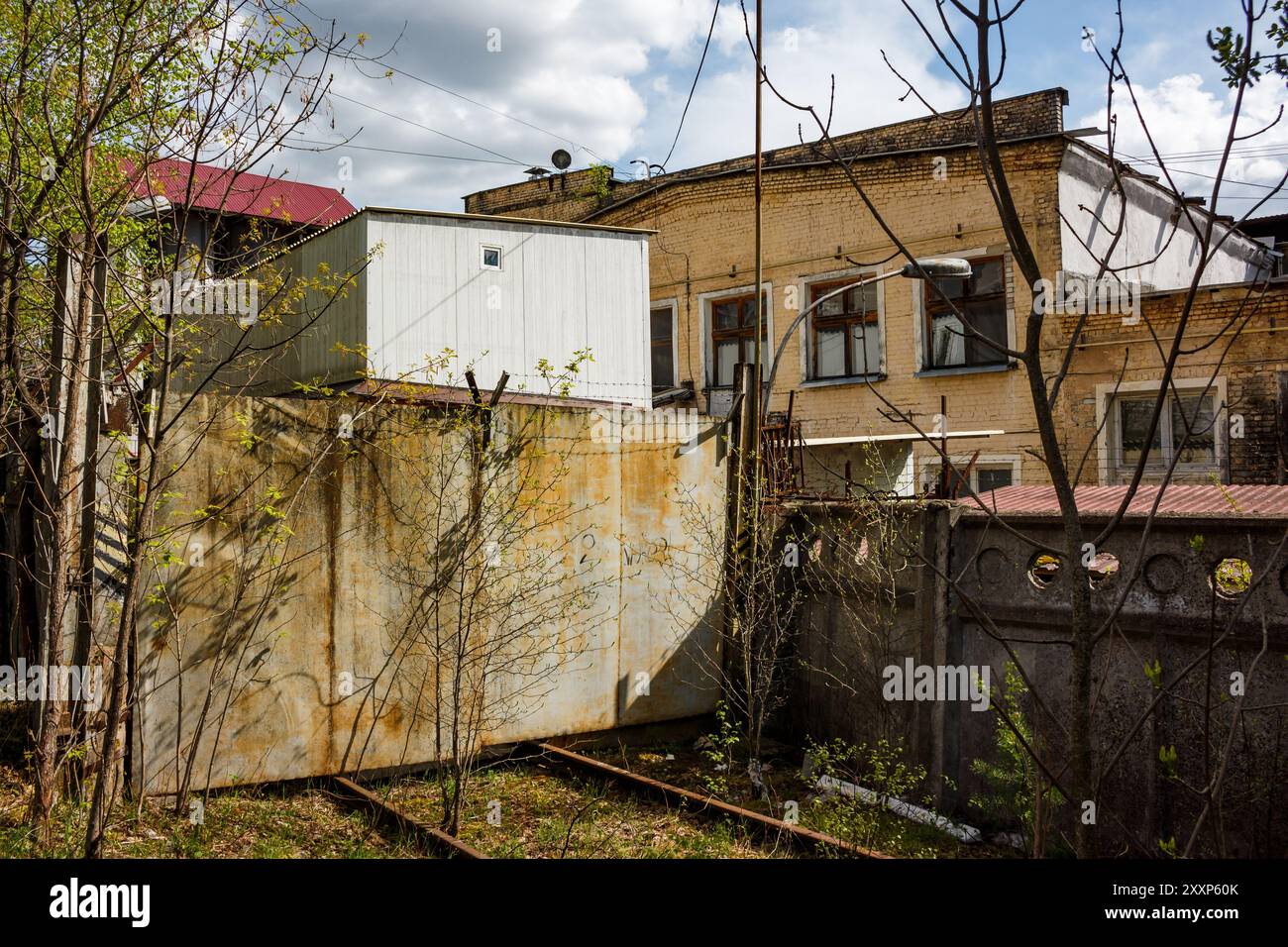Factory territory behind a fence with barbed wire, old industrial ...
