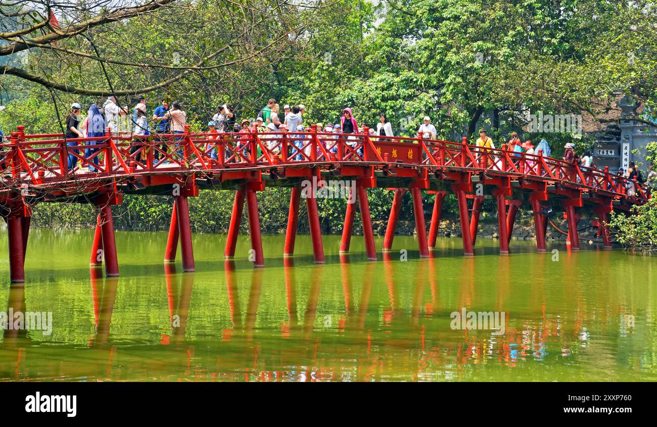 Hanoi, Vietnam - April 14, 2015: Tourists on the Red Bridge (also known as The Huc Bridge) over ...