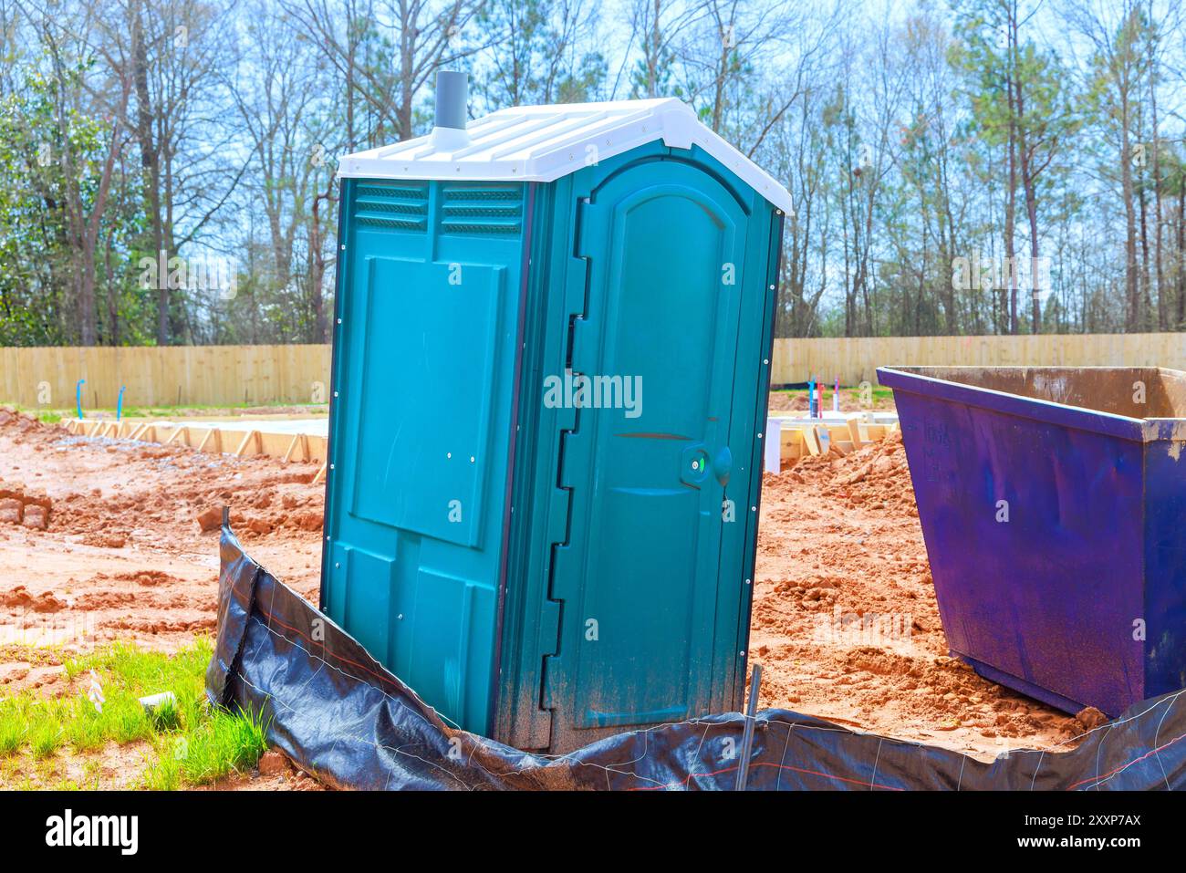 During construction of house, portable plastic bio toilet stalls are ...