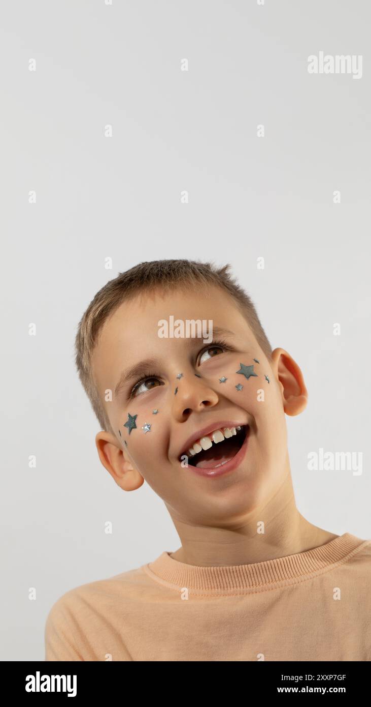 Dreaming smiling boy with stars on face and design template Stock Photo ...
