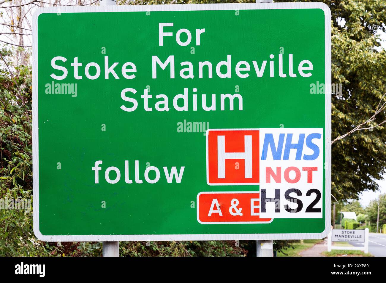 A413 Stoke Mandeville roadside sign for Stoke Mandeville Hospital and Stadium with anti HS2 sign ...