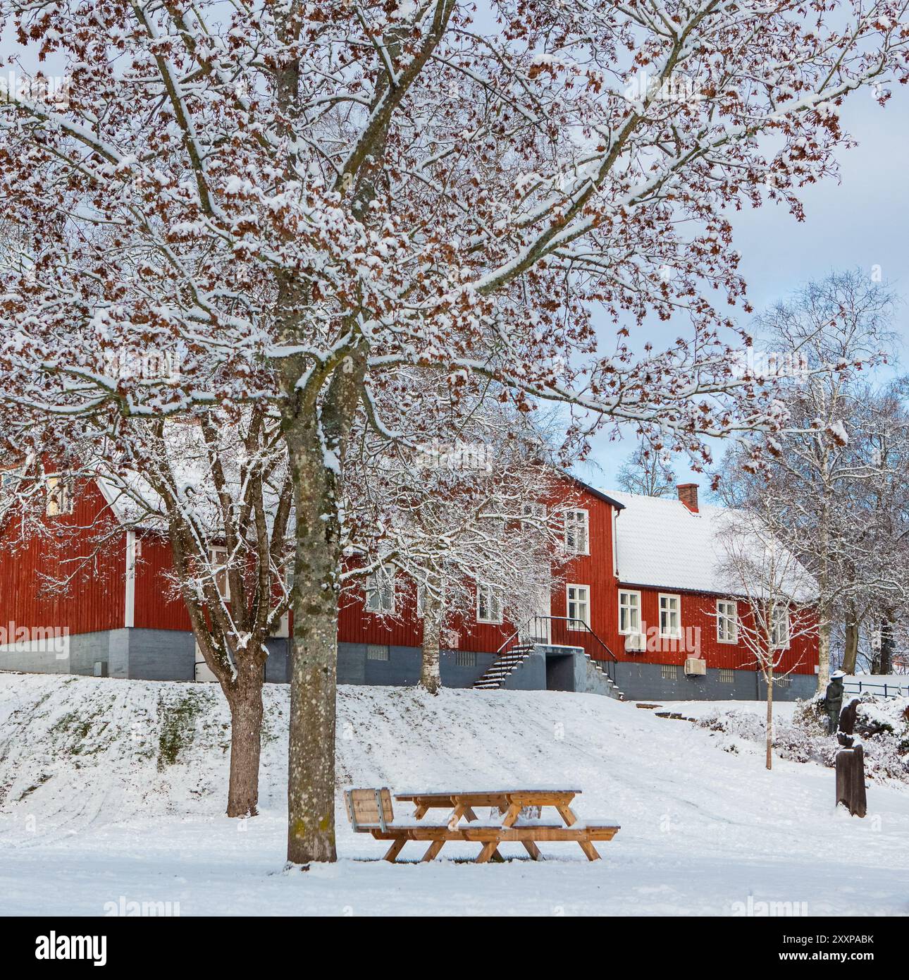 Red museum building in winter in Hembygdsparken park in Hassleholm ...