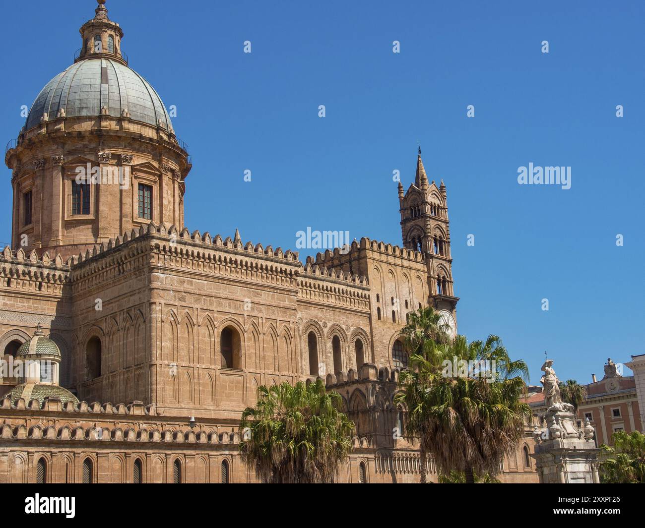 Large cathedral with dome and gothic elements and palm trees under a ...