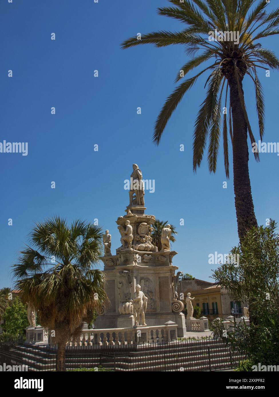 Historical monument surrounded by tall palm trees and blue sky in the ...