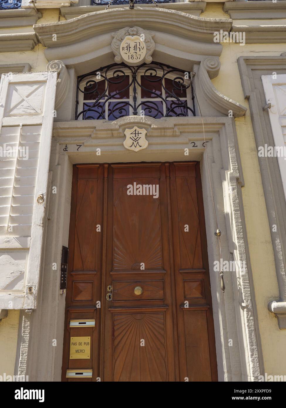 Old wooden door with decorative sign and lettering in a historic ...