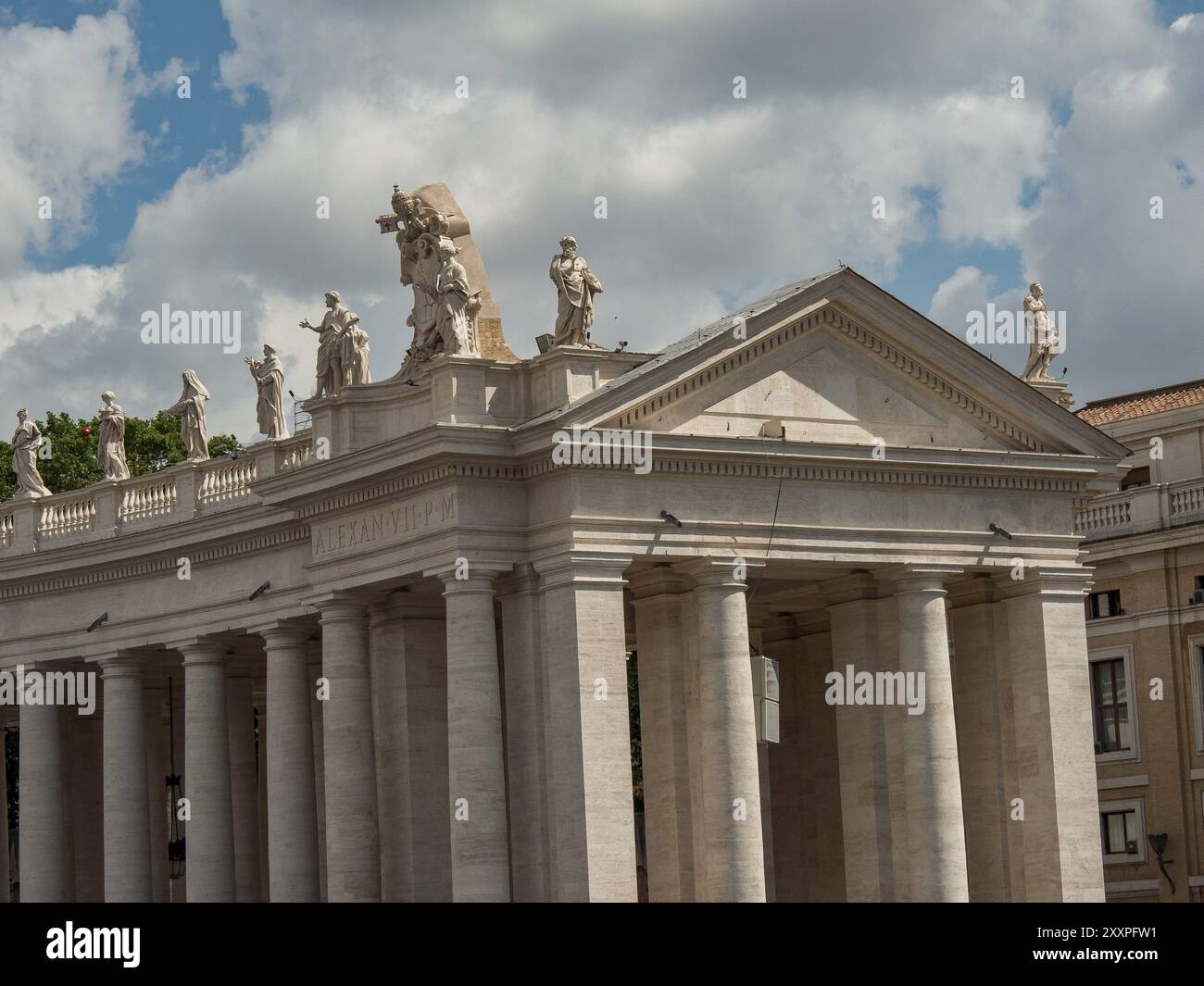 Impressive building with classical columns and statues under a cloudy ...