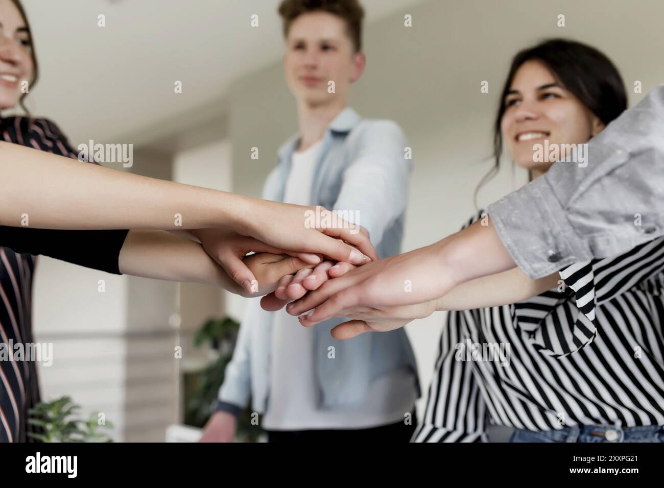 Friendly group of people doing handshake and cross hands. Friendship ...