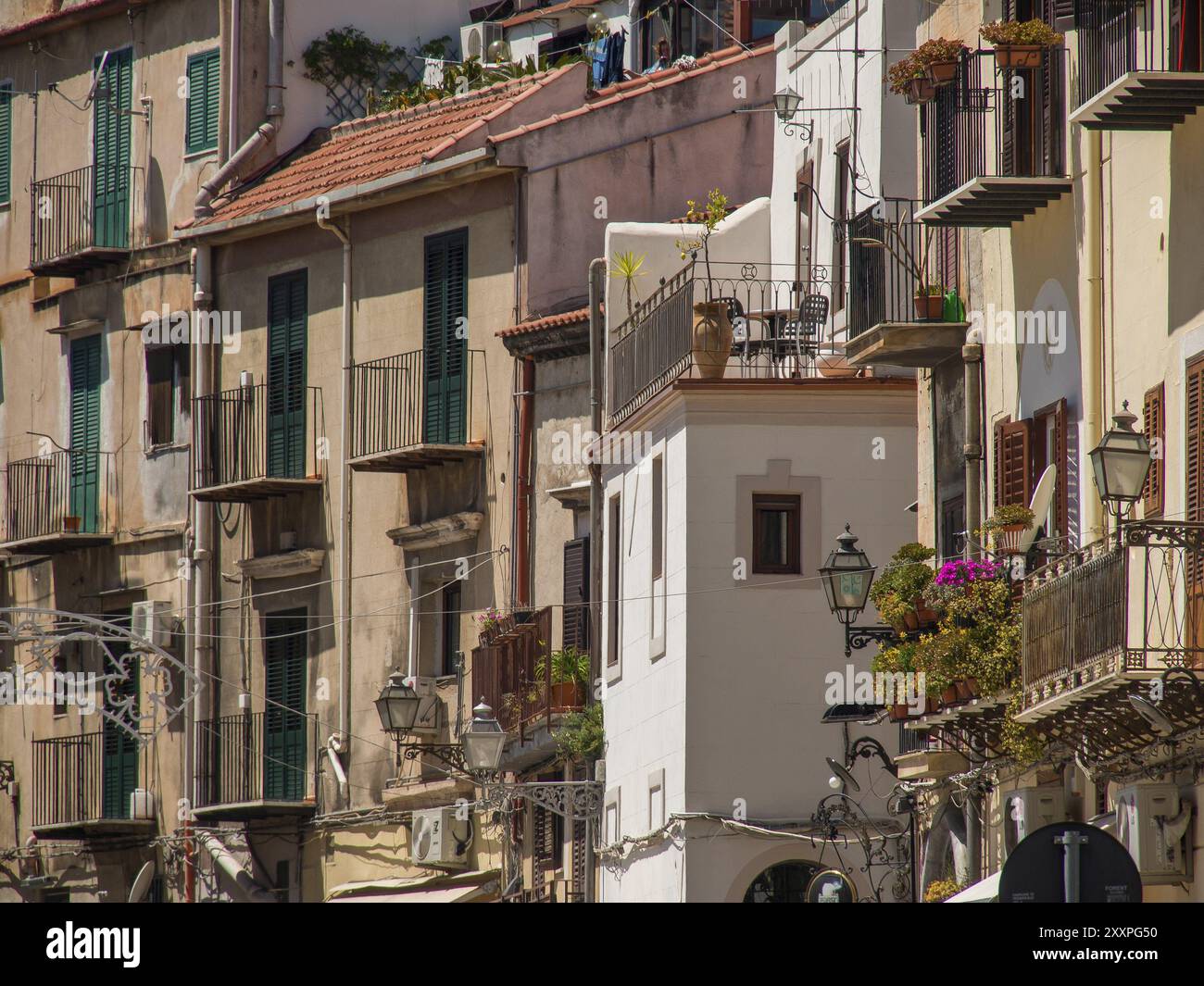 View of several old-fashioned buildings with balconies and living ...