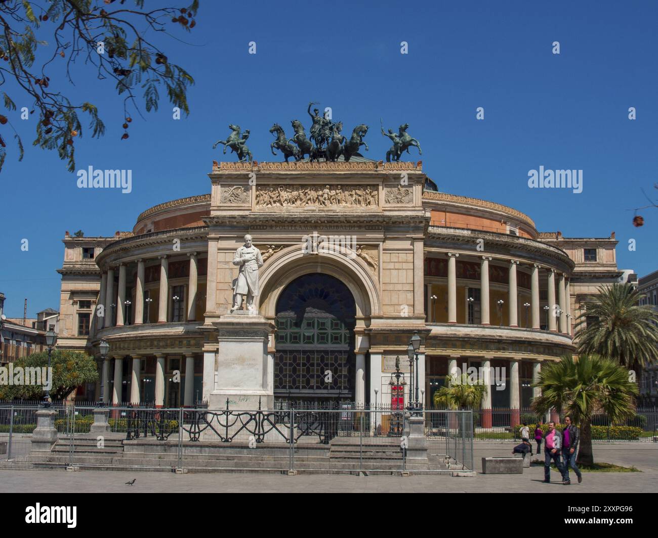 Round theatre building with statue and dome in classical style, sunny ...