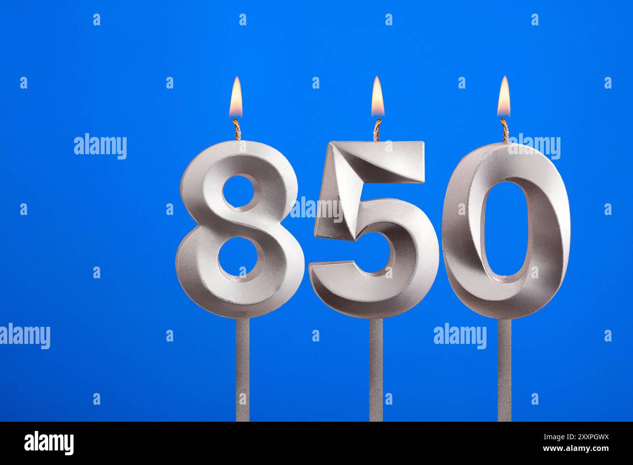 Birthday number 850 - Candle lit on blue background Stock Photo - Alamy