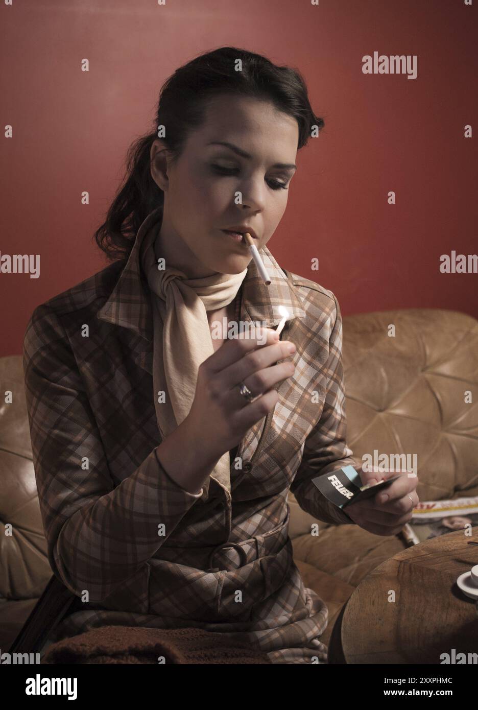 Woman smoking a cigarette in a chequered jacket Stock Photo - Alamy
