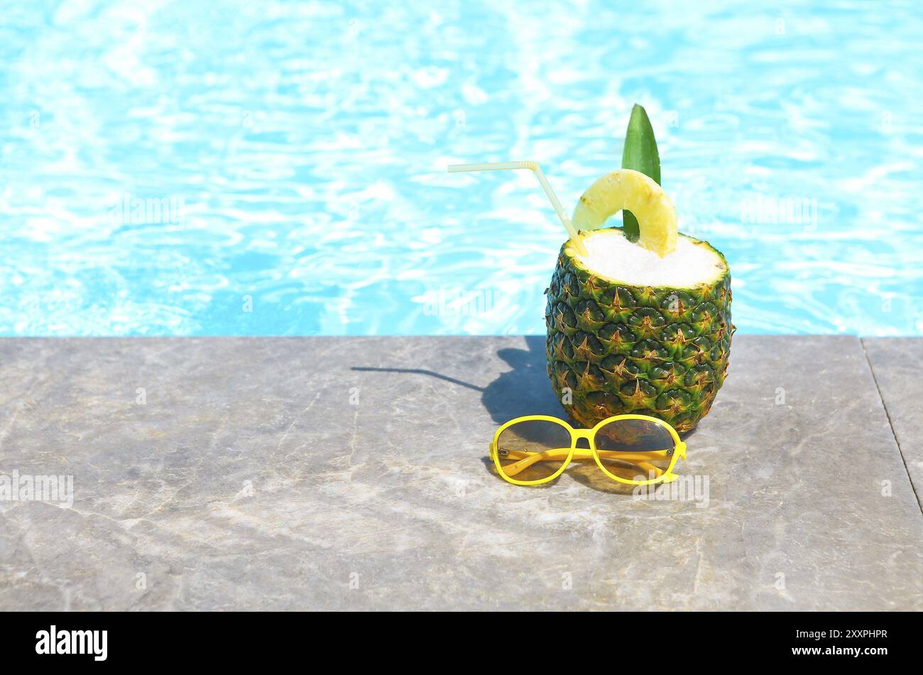 Exotic pineapple cocktail near pool. Pina colada Stock Photo - Alamy