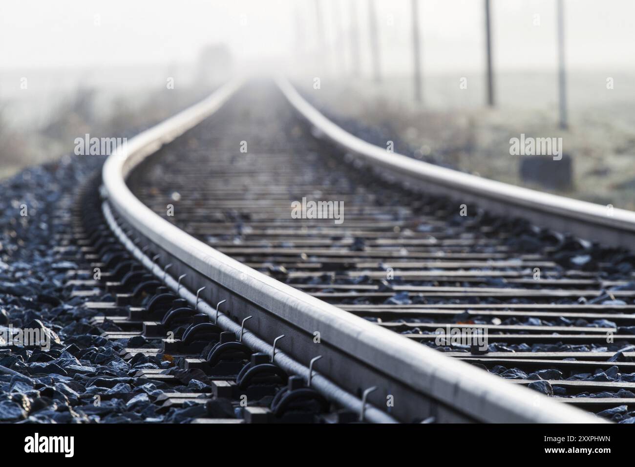 Single-track railway line in the morning fog Stock Photo - Alamy