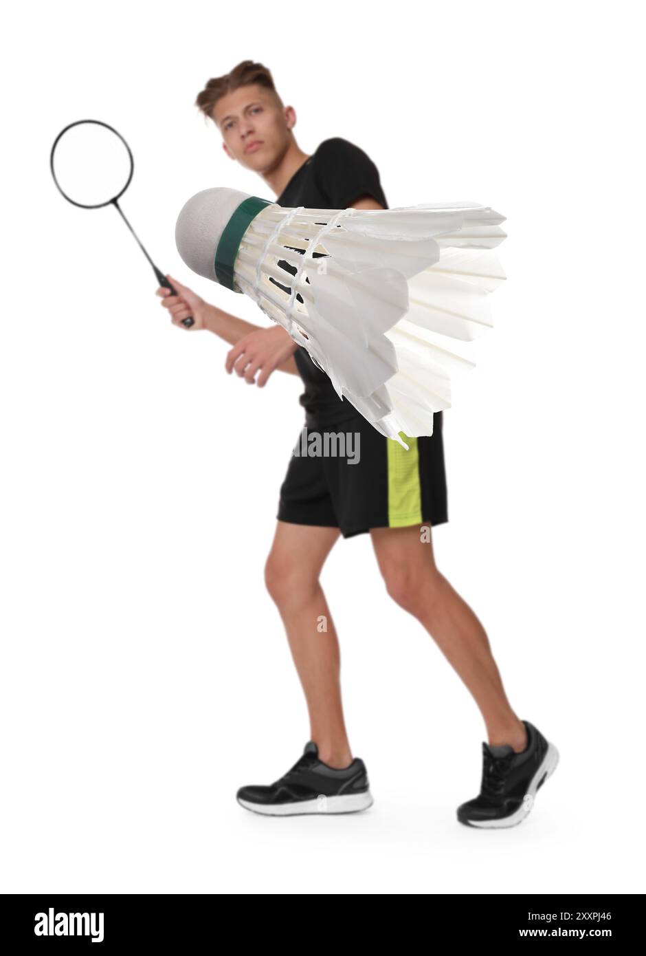 Young man playing badminton with racket and feather shuttlecock on ...