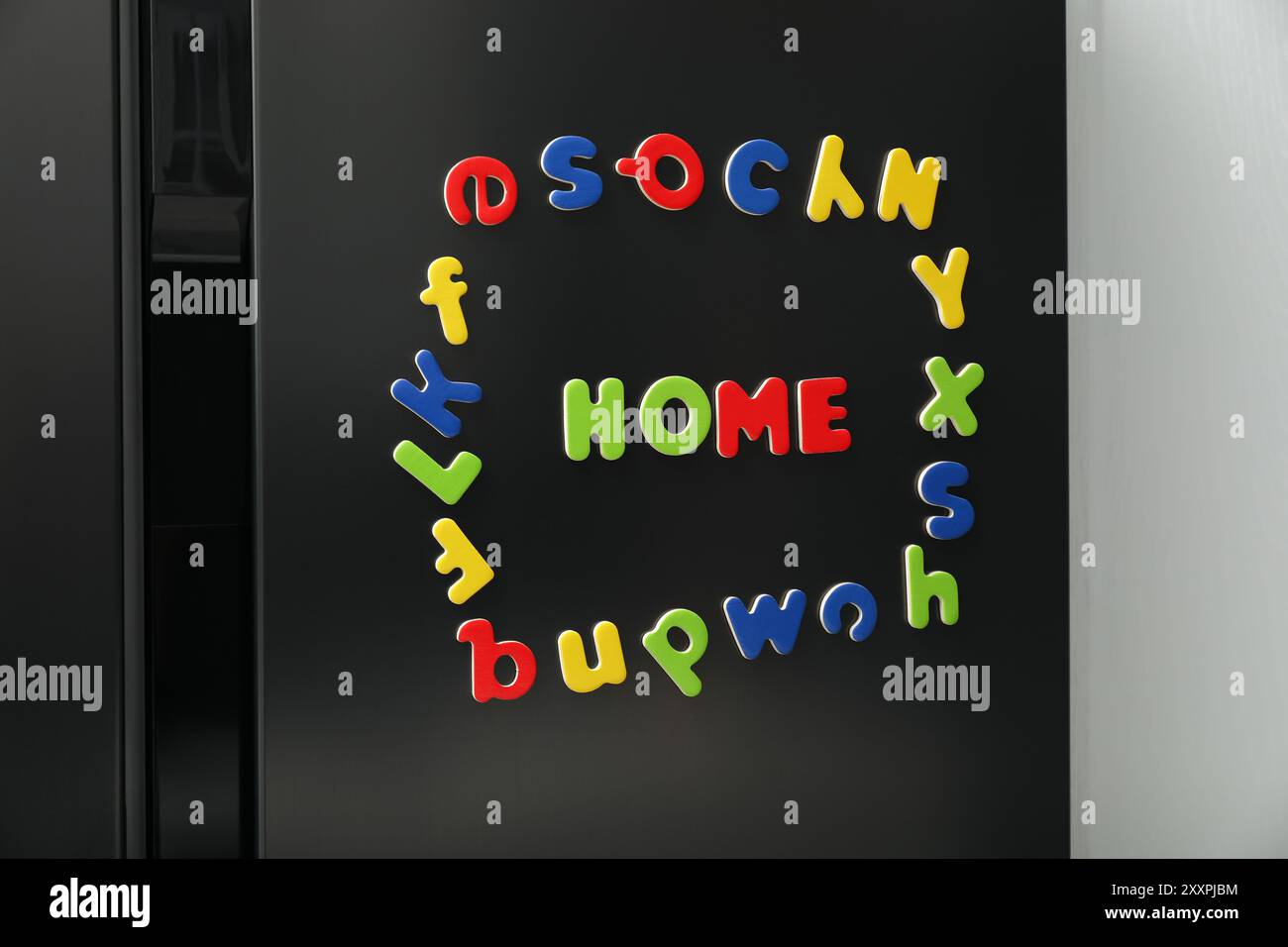 Word Home and frame made of many bright magnetic letters on fridge ...