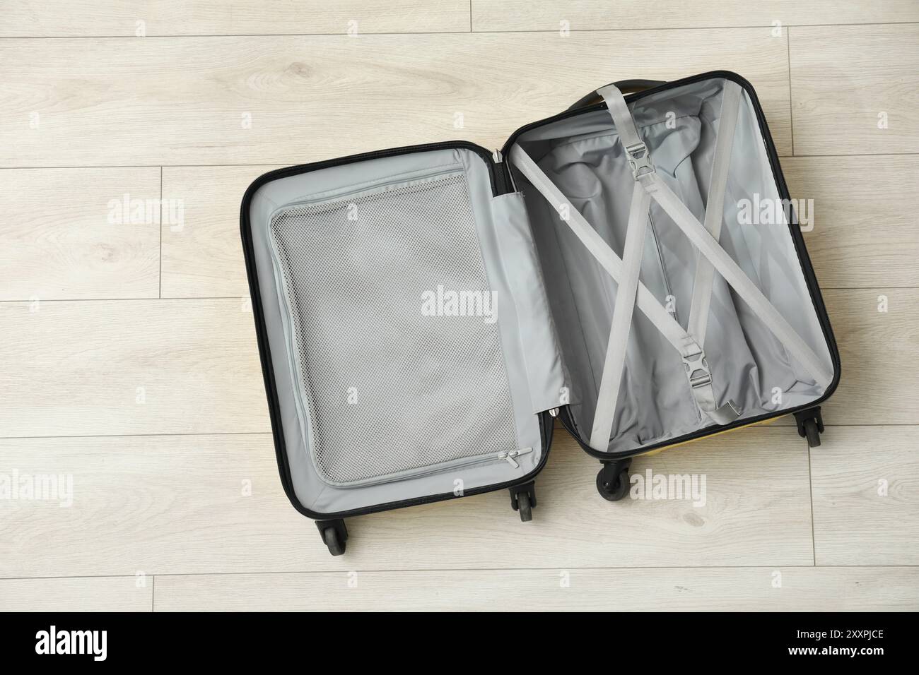 Open empty suitcase on floor indoors, top view. Space for text Stock ...