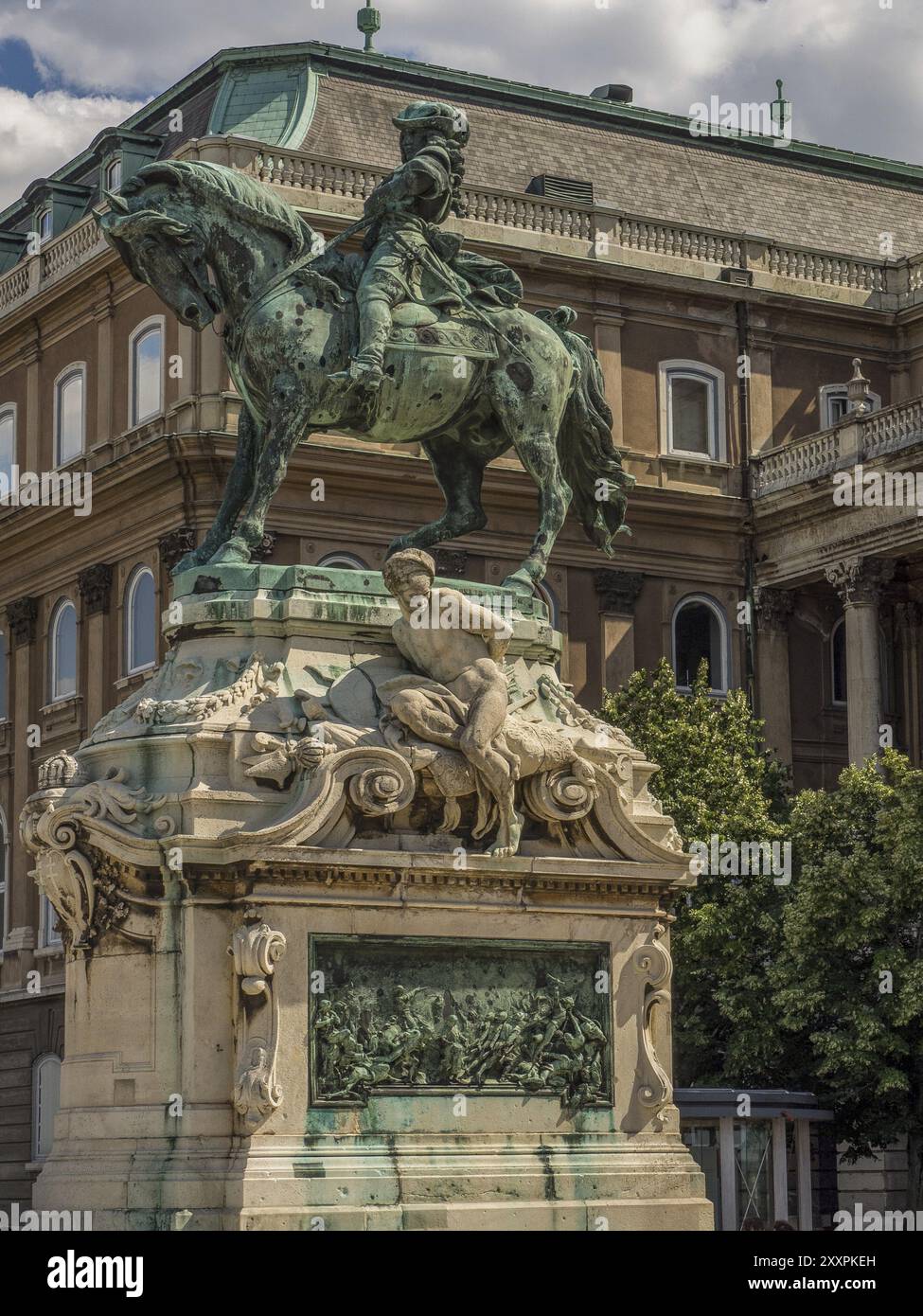 Bronze statue of a horseman on an ornate pedestal in front of a ...