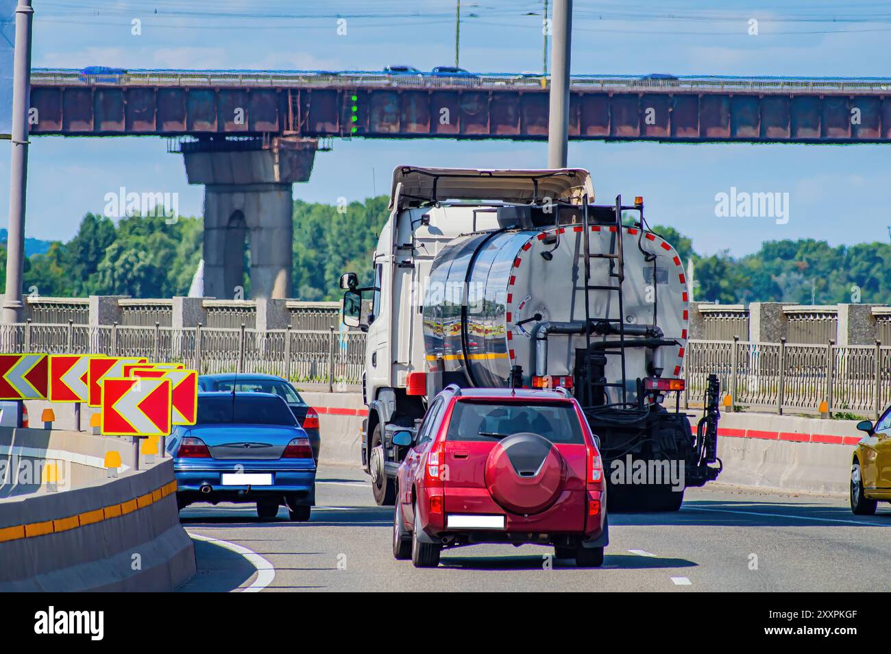 Car fuel tank on the city highway. Truck with cargo. City traffic ...