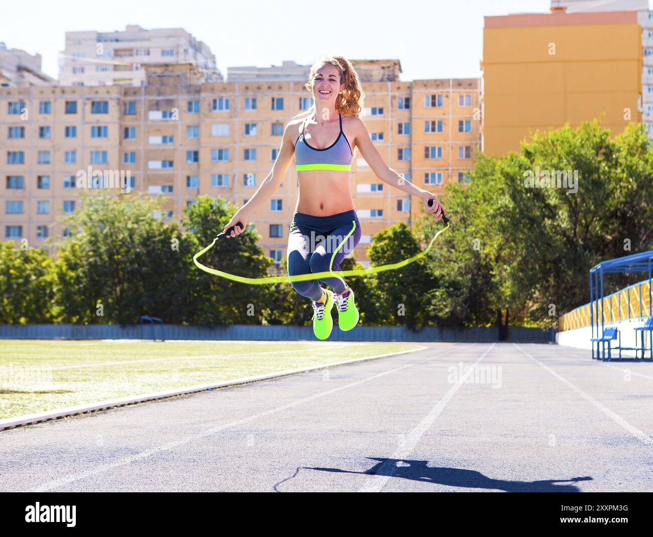 Woman with jumping rope. Beautiful young woman with a jumping rope in ...