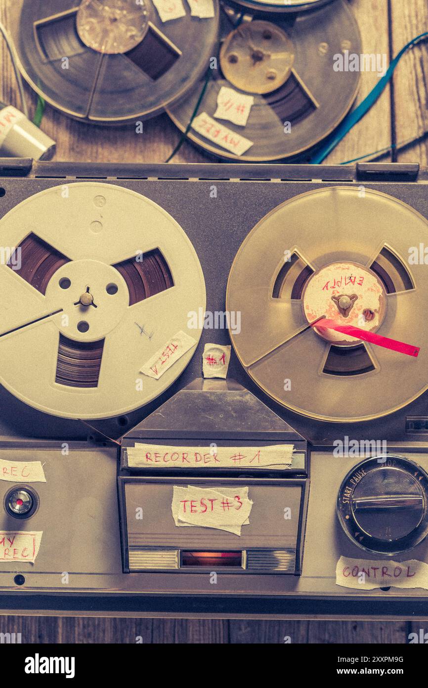 Classic audio tape recorder and a used rolls of tape. Recording reel-to ...