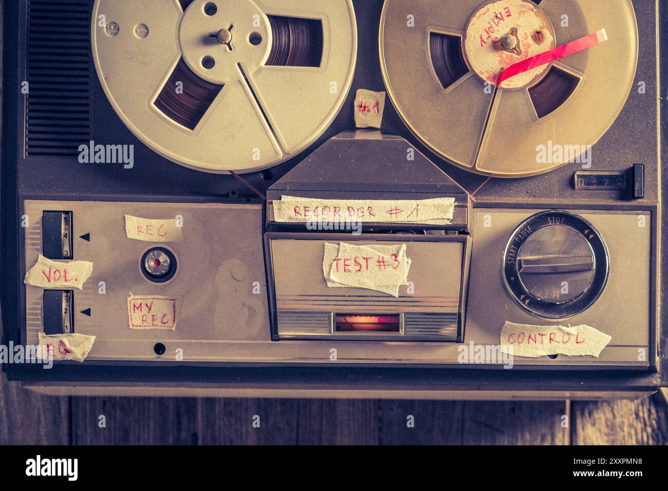 Retro reel-to-reel tape recorder and a used rolls of tape. Recording ...