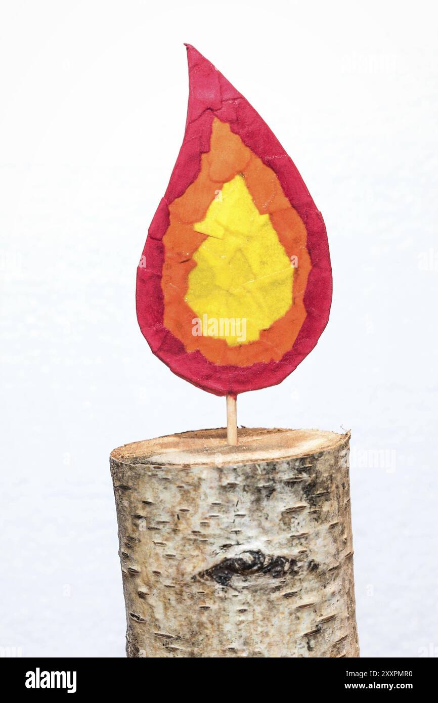 Wooden candle with coloured handmade flame Stock Photo - Alamy