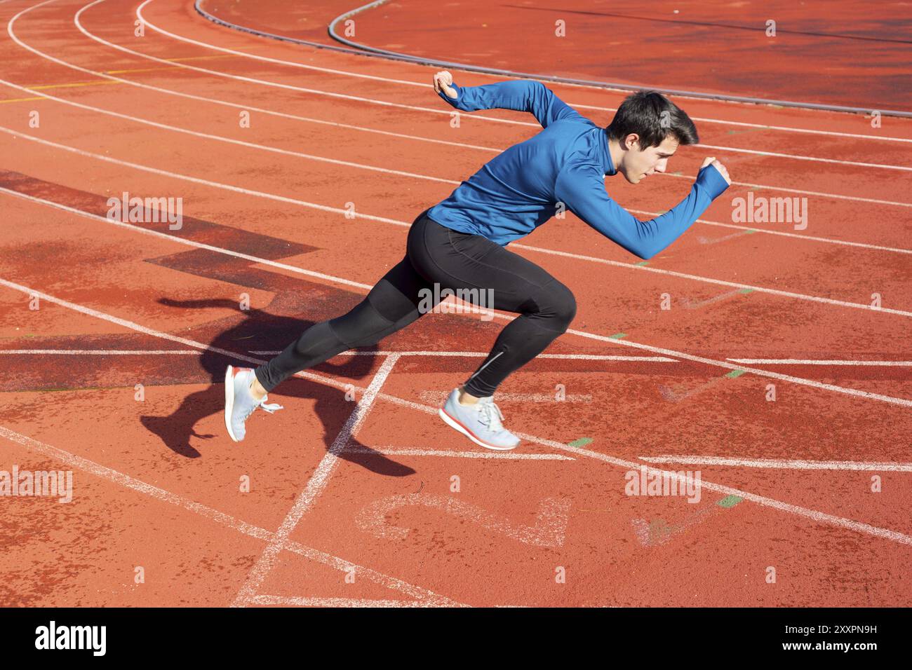 Runner starting his sprint on running track in a stadium Stock Photo ...