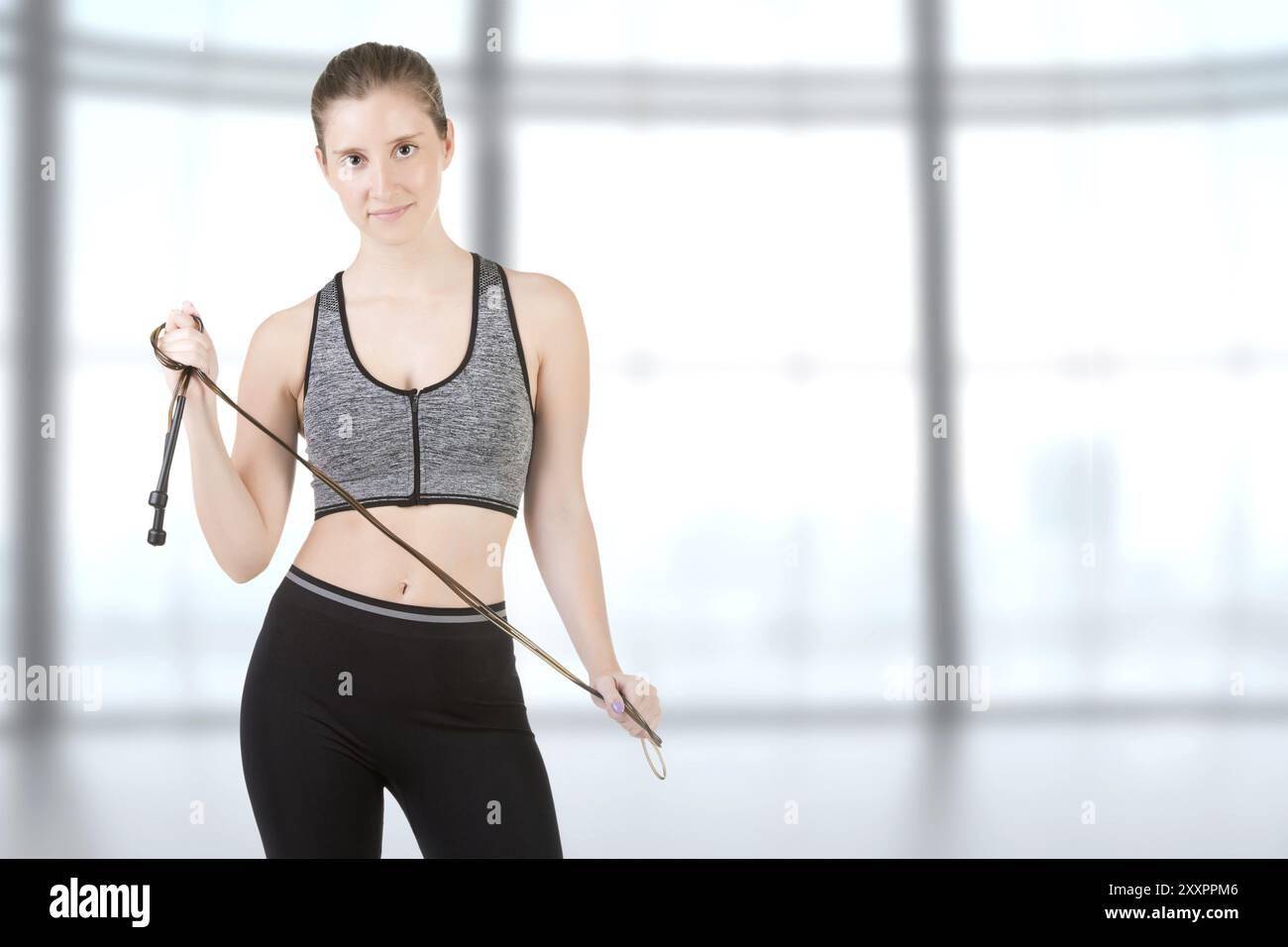 Back of sporty woman with a jumping rope Stock Photo - Alamy