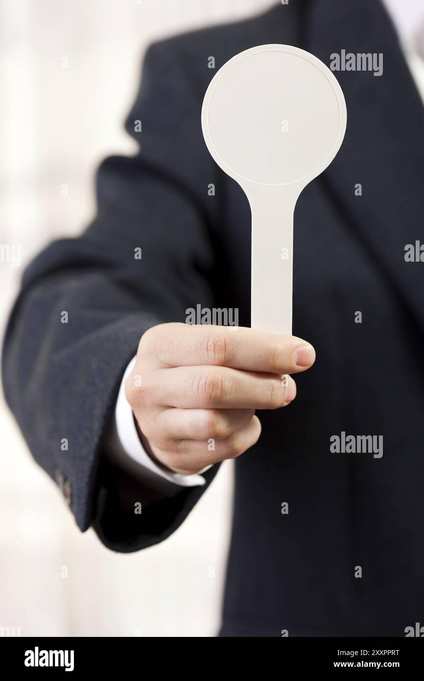 Human hand holding auction paddle voting card sign Stock Photo - Alamy