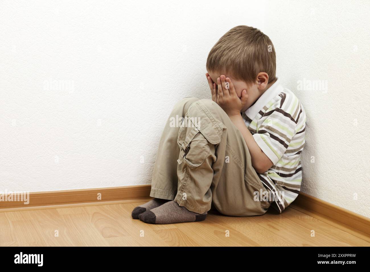 Little child boy wall corner punishment standing Stock Photo - Alamy