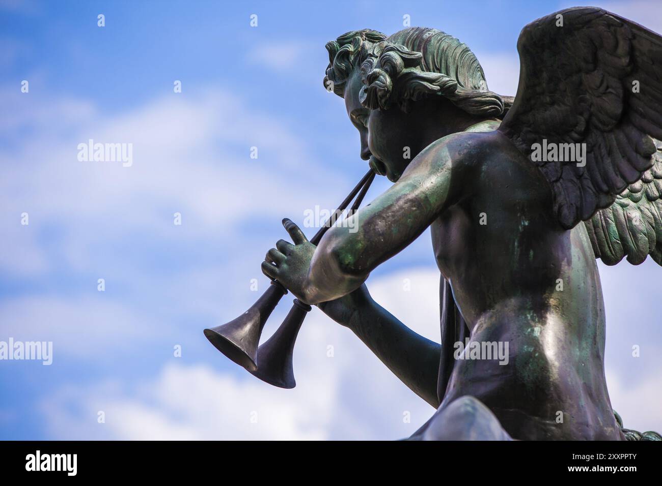 Statue of an angel playing a trumpet with two horns Stock Photo - Alamy