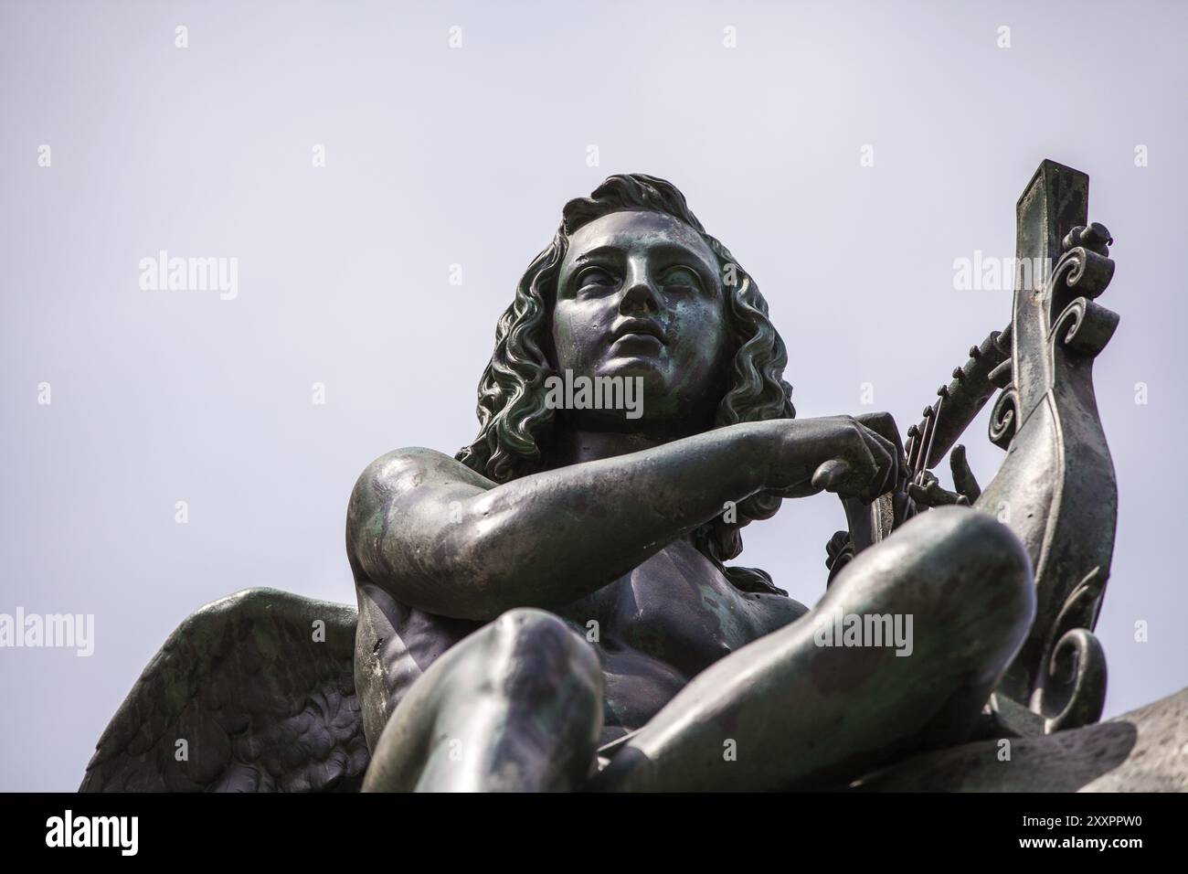 Statue of an angel playing the harp taken from below Stock Photo - Alamy