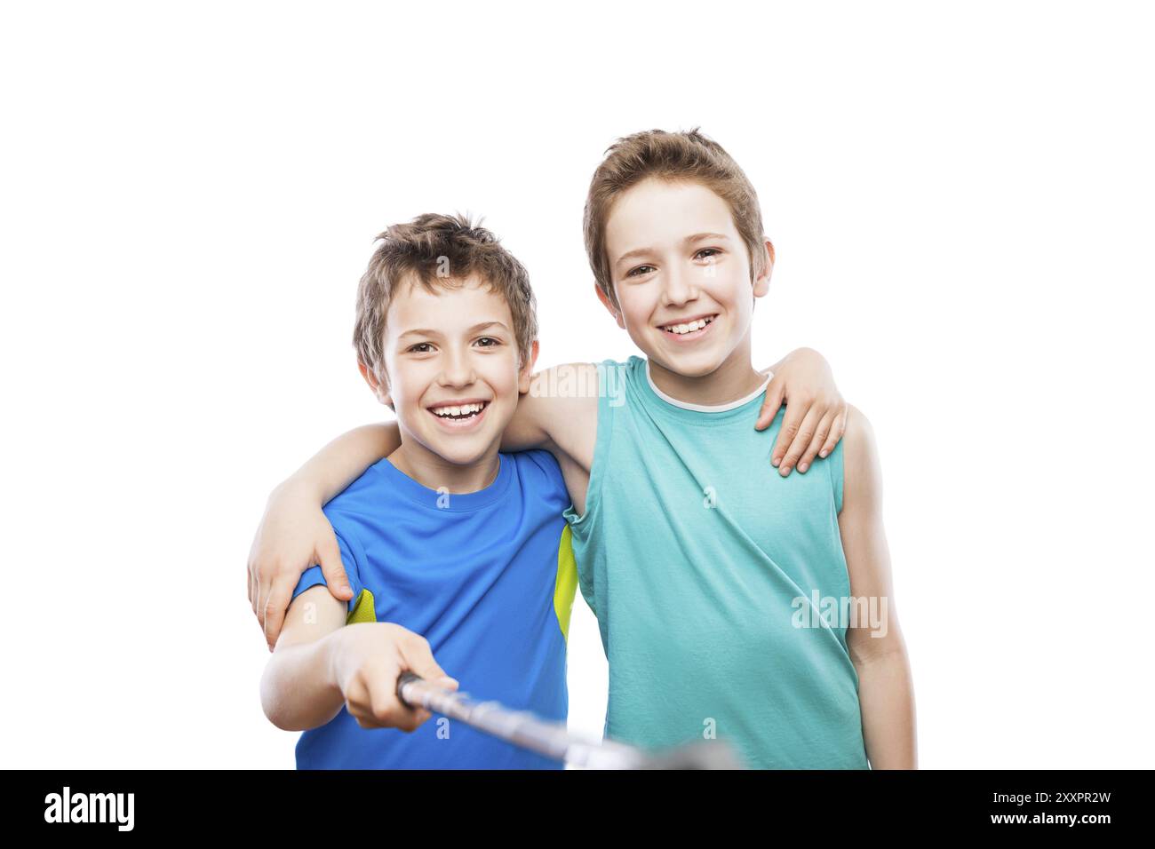 Two handsome smiling child boy brothers hand holding mobile phone or ...
