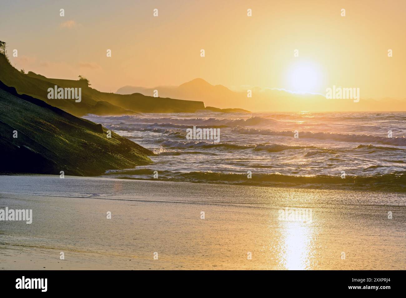 Tropical sunrise at Devil beach with Copacabana Fort in the background ...