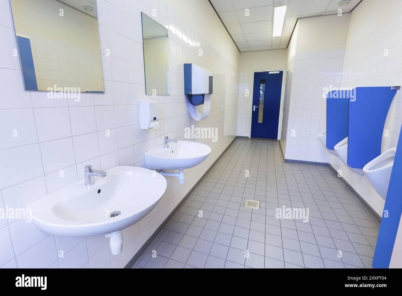Toilet room for boys with urinals sinks and mirrors on high school ...